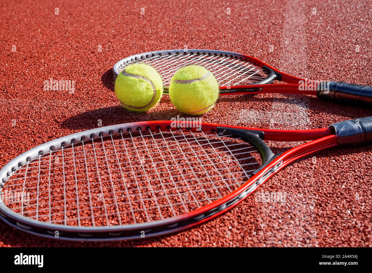 Low angle view tennis scene with balls, racquets and hard court surface ...