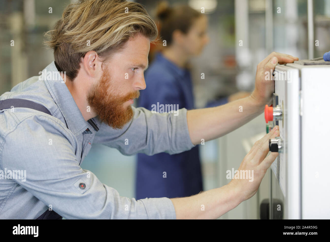 factory operative setting up machinery Stock Photo - Alamy