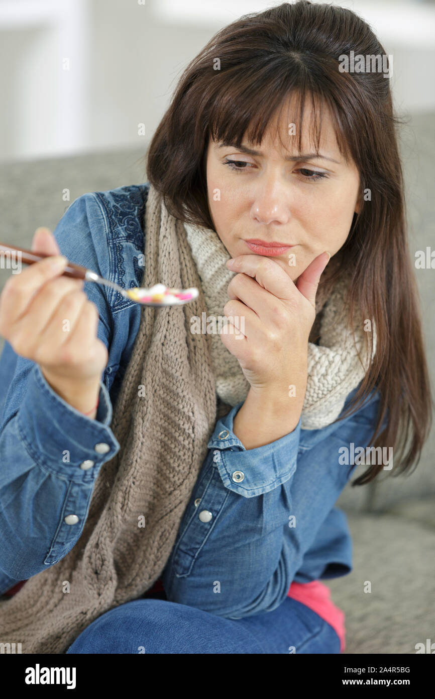 Woman unsure pills hi-res stock photography and images - Alamy