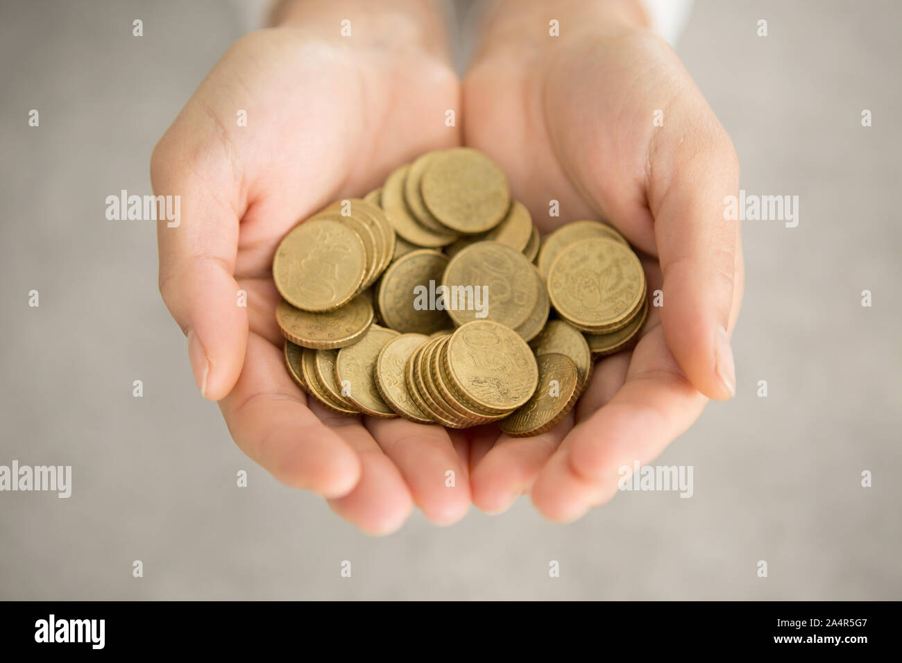 woman holding coins in hand Stock Photo - Alamy