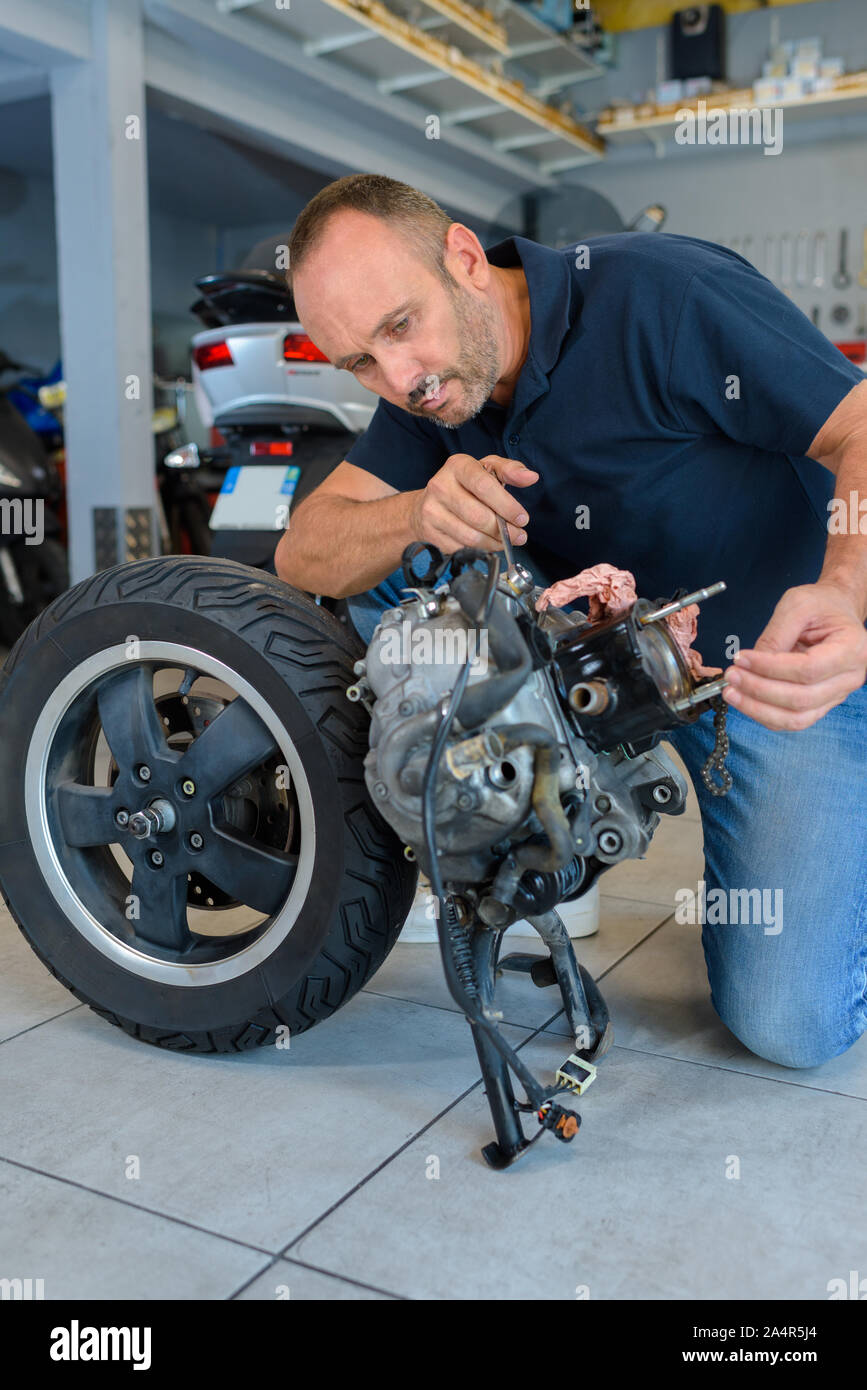 a man fixing an engine Stock Photo - Alamy
