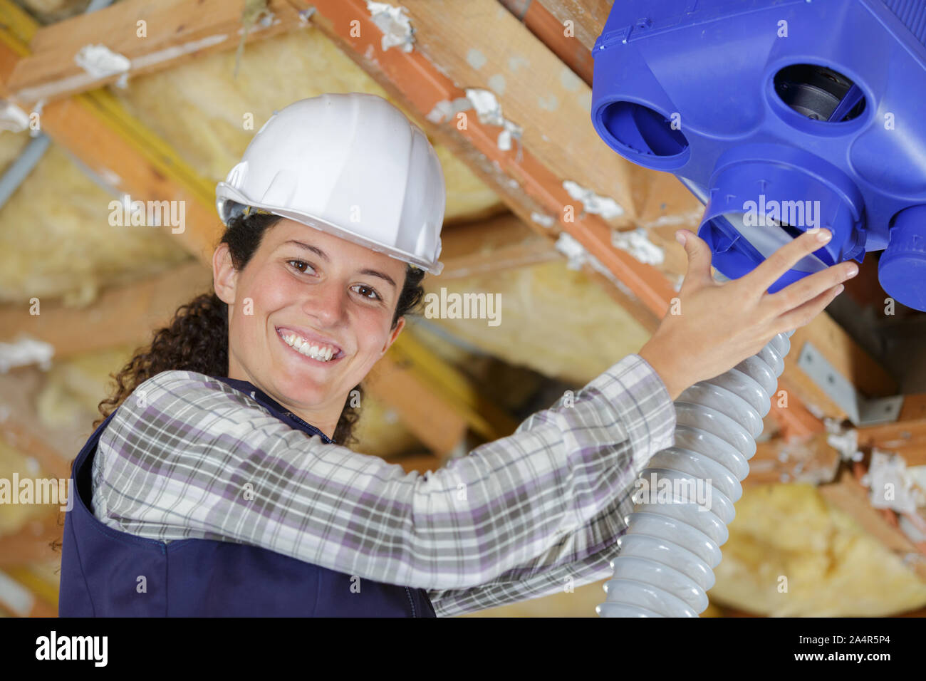 happy handywoman cleaning fixing ventilation system Stock Photo - Alamy