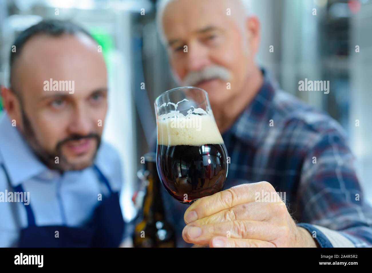 workers adoring the frothy beer Stock Photo - Alamy