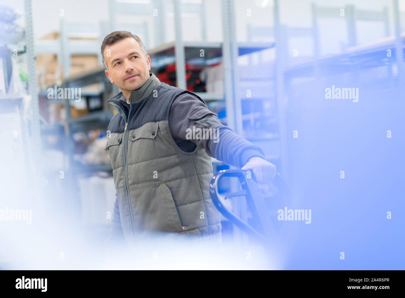 warehouse worker pulling a pullcart Stock Photo - Alamy