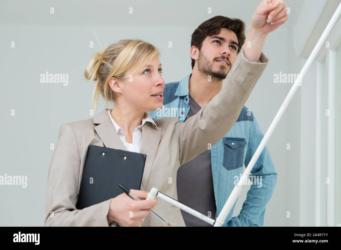 Happy estate agent posing sale hi-res stock photography and images - Alamy