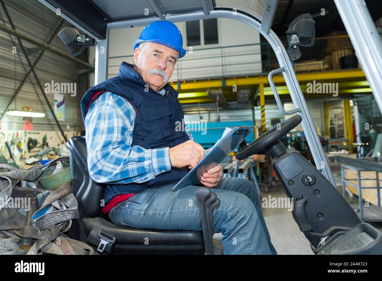 forklift driver in industrial logistics warehouse Stock Photo - Alamy