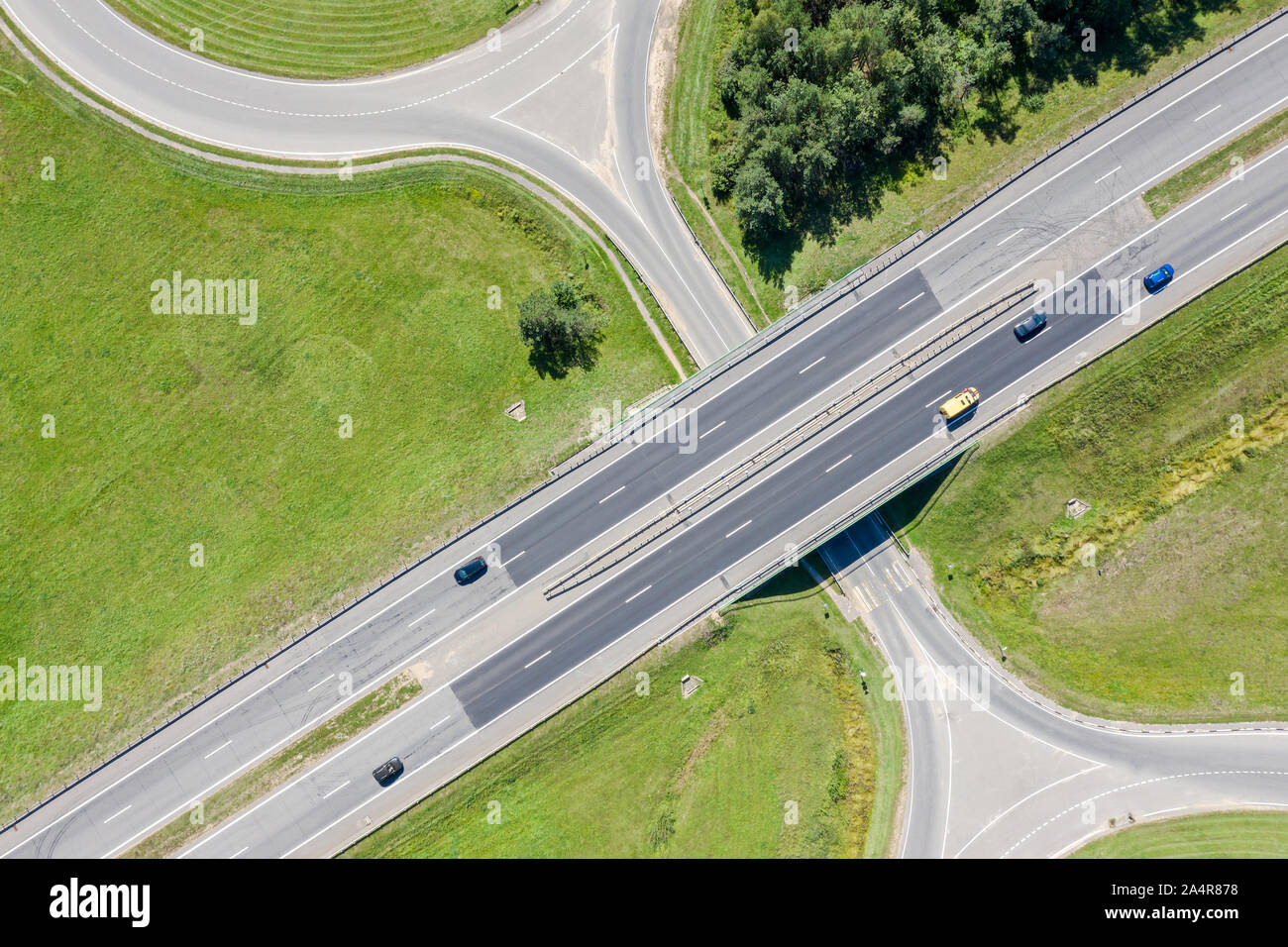 aerial view of suburb road intersection on summer green field ...