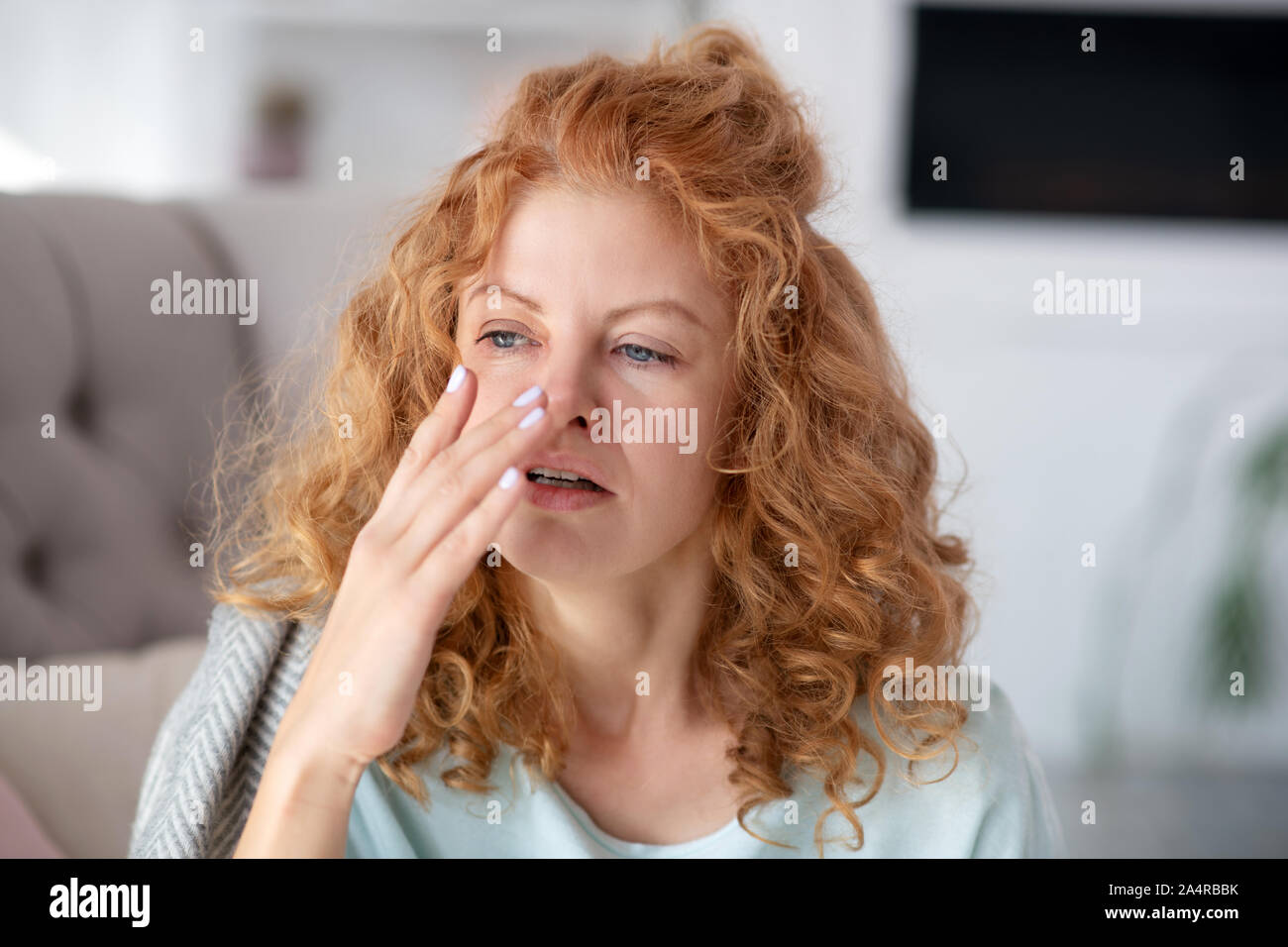 Woman sneezing and coughing while having cold Stock Photo - Alamy