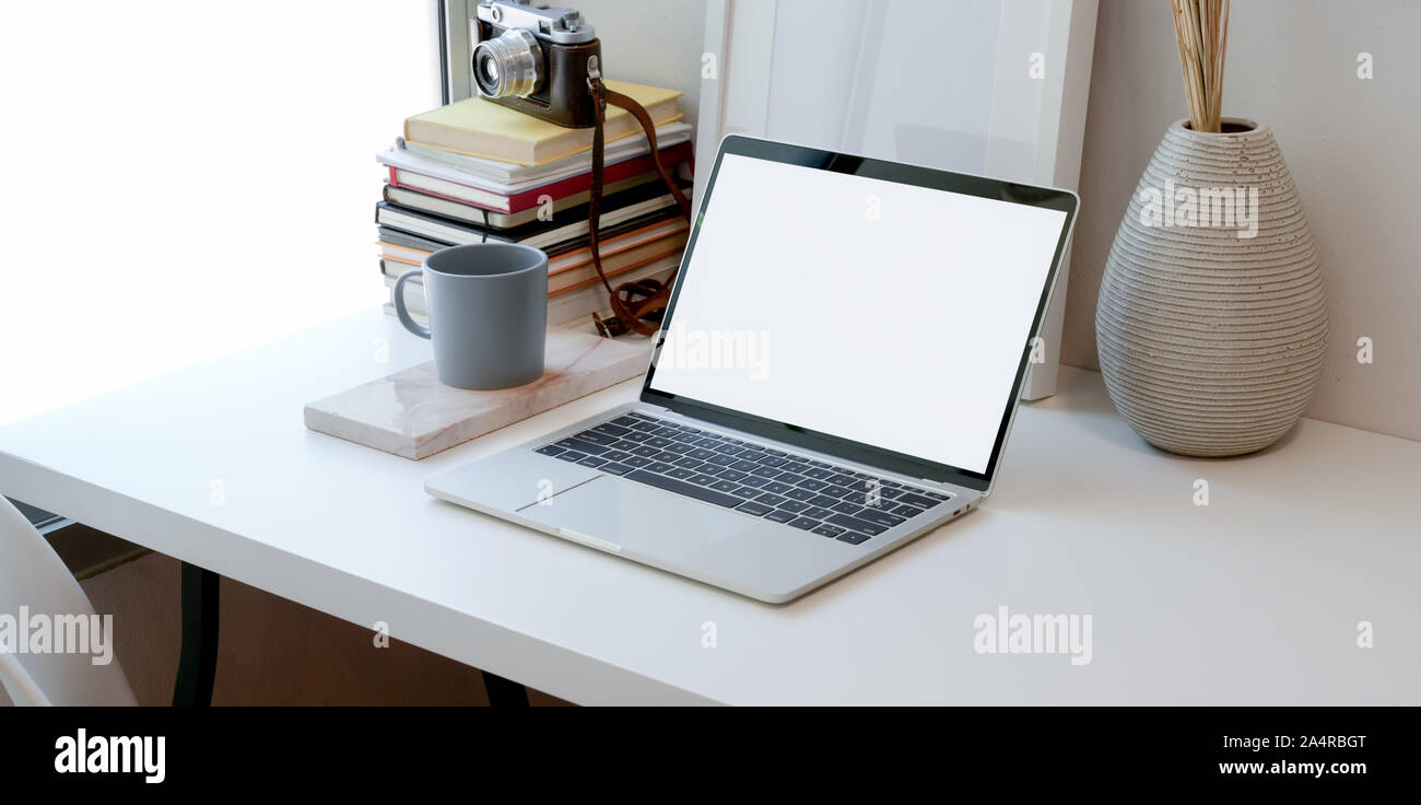 Open blank screen laptop computer in minimal workspace with office ...