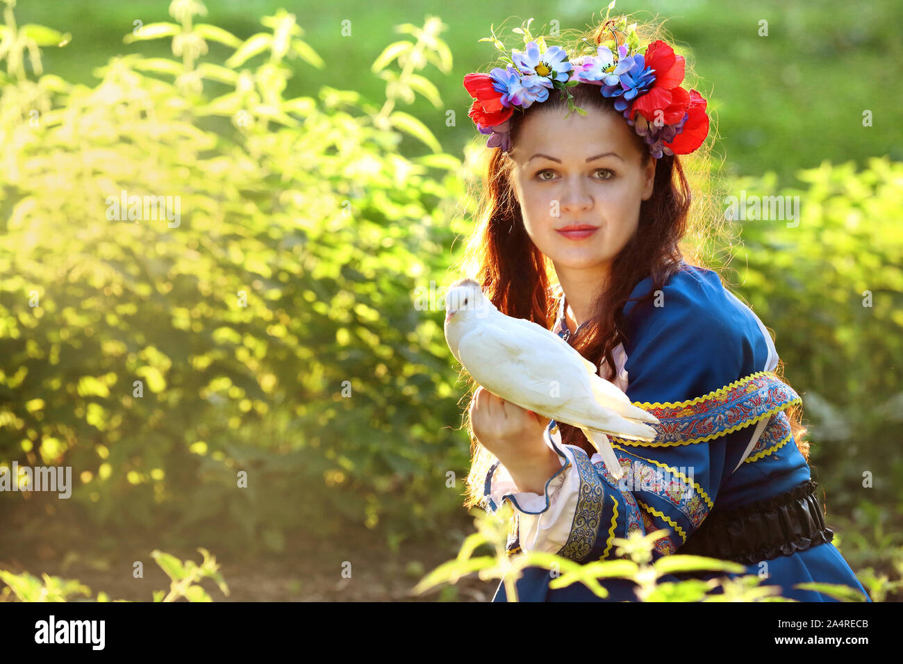 Beautiful girl in a Cossack outfit with a white dove Stock Photo - Alamy