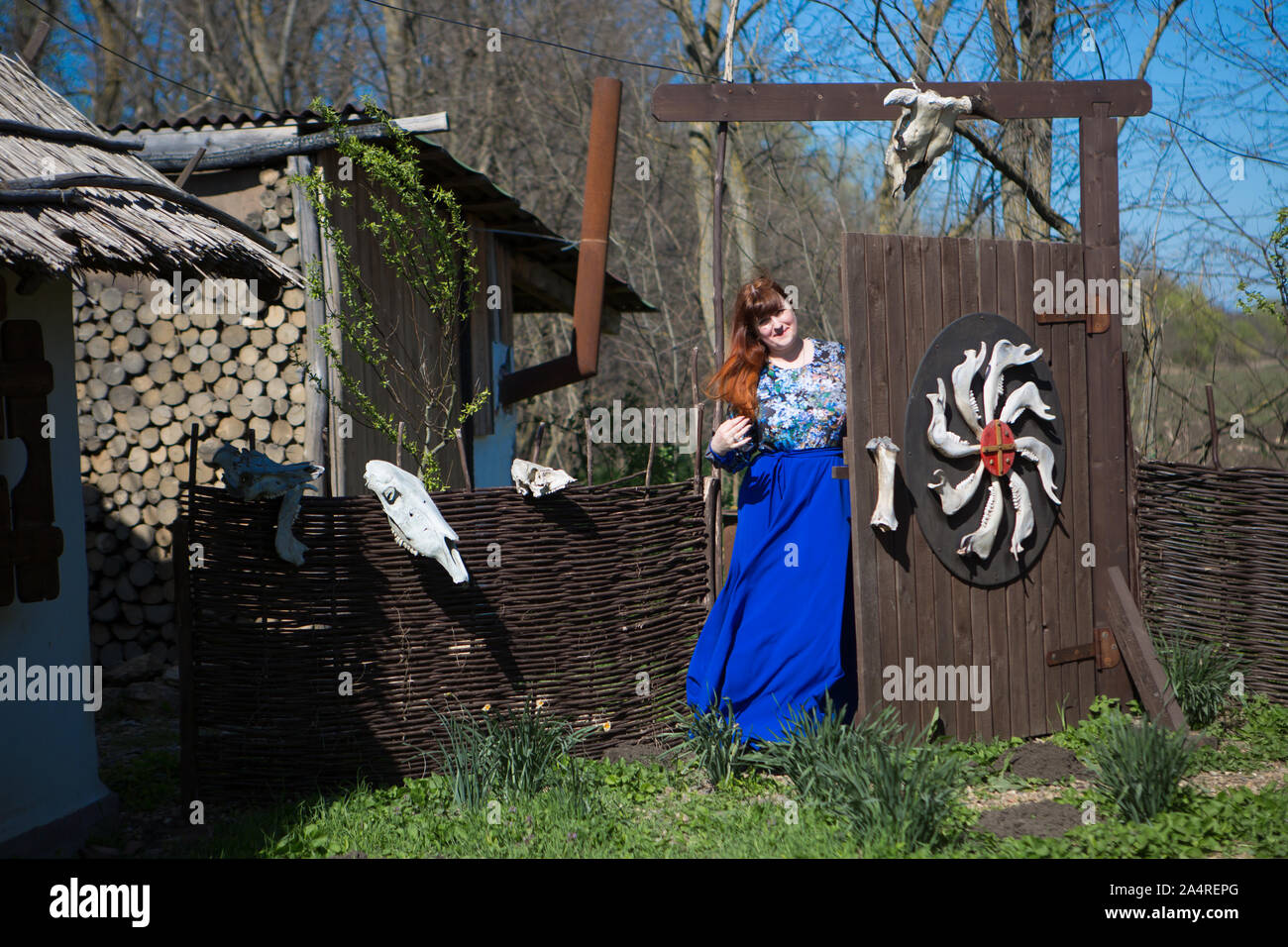 Girl near the old pagan house Stock Photo - Alamy