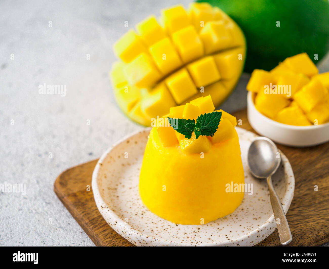 Mango Mousse on gray cement background with copy space left. Yellow ...