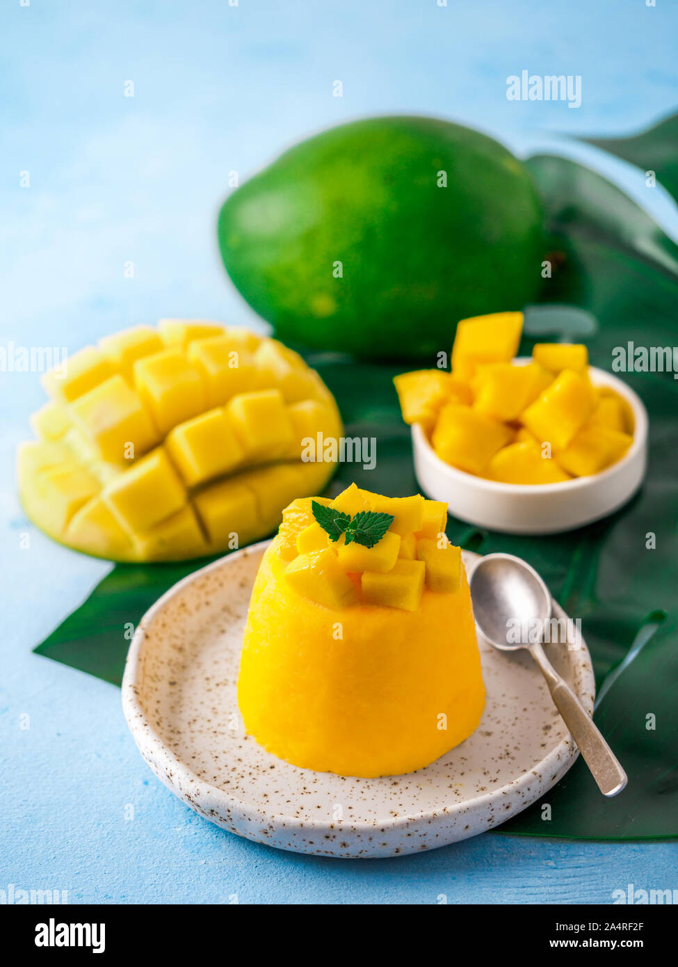 Mango Mousse on blue background with copy space left. Delicious yellow ...