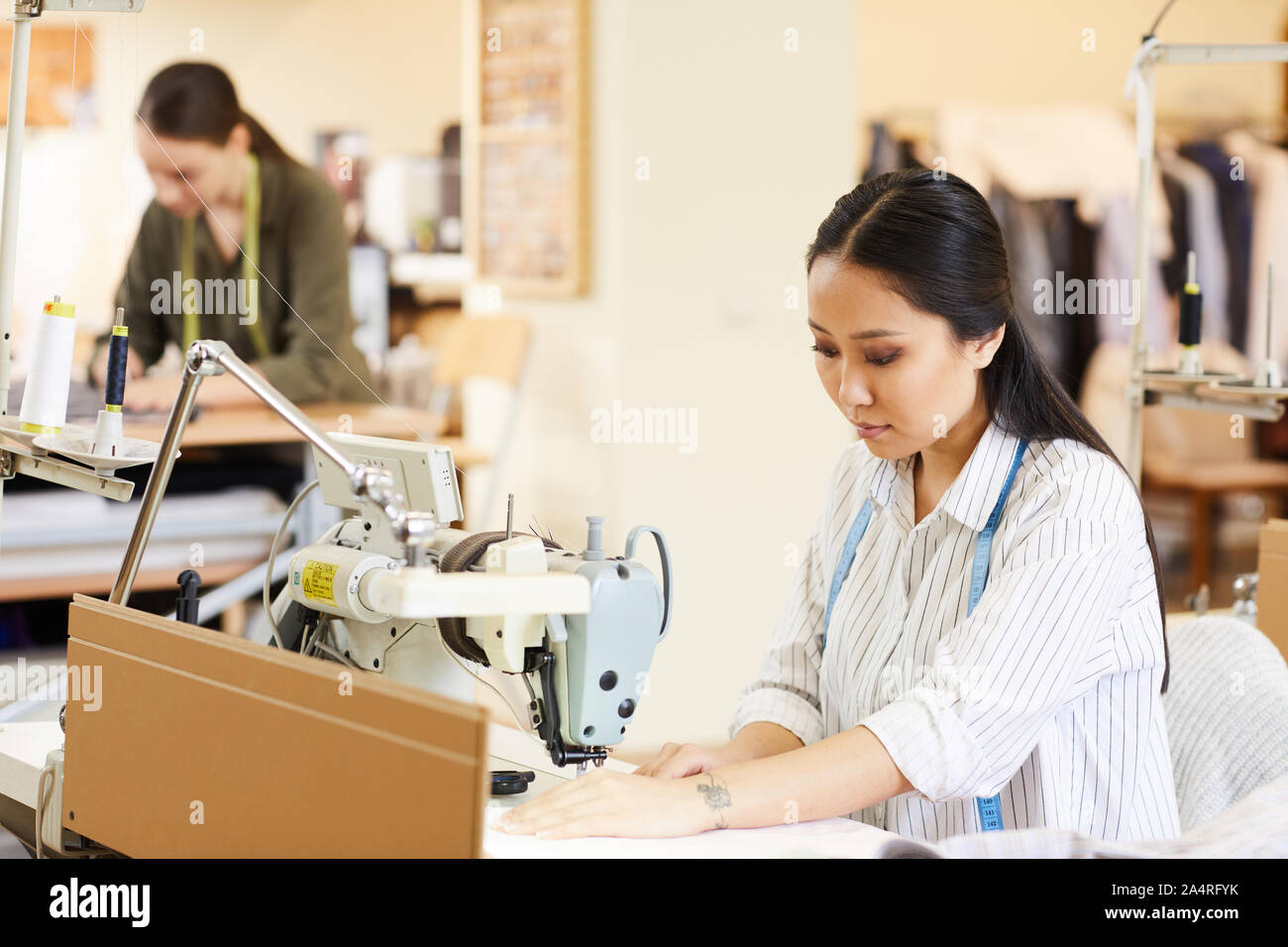 Asian women using sewing machine hi-res stock photography and images ...