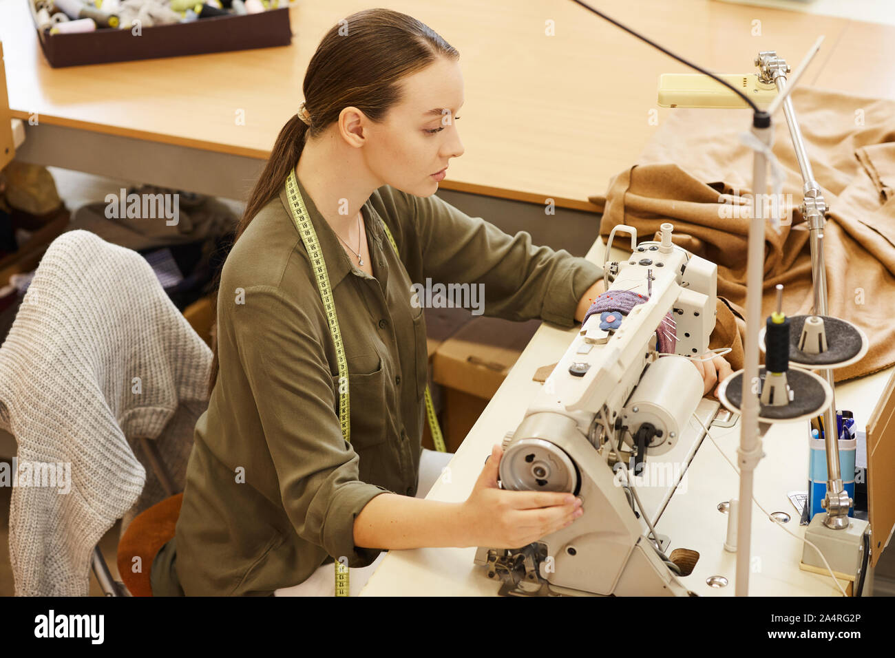 Smiling woman using sewing machine hi-res stock photography and images ...