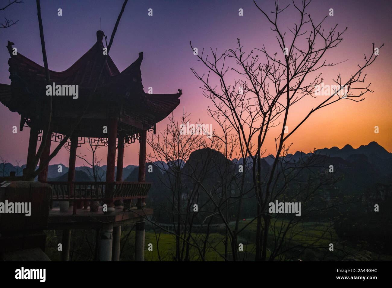 Sunset with pavilion and Rapeseed flower field at Wanfenglin National ...