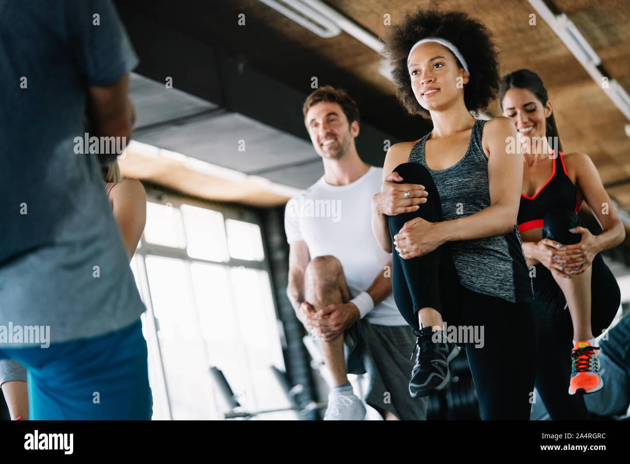 Beautiful fit people exercising together in gym Stock Photo - Alamy