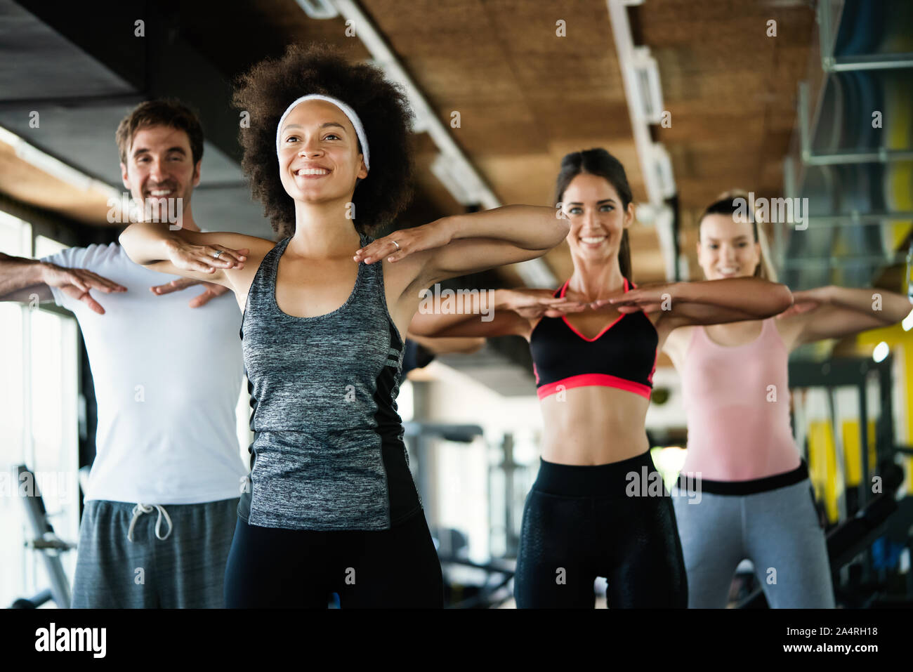 Group of happy multiracial friends exercising together in gym Stock ...