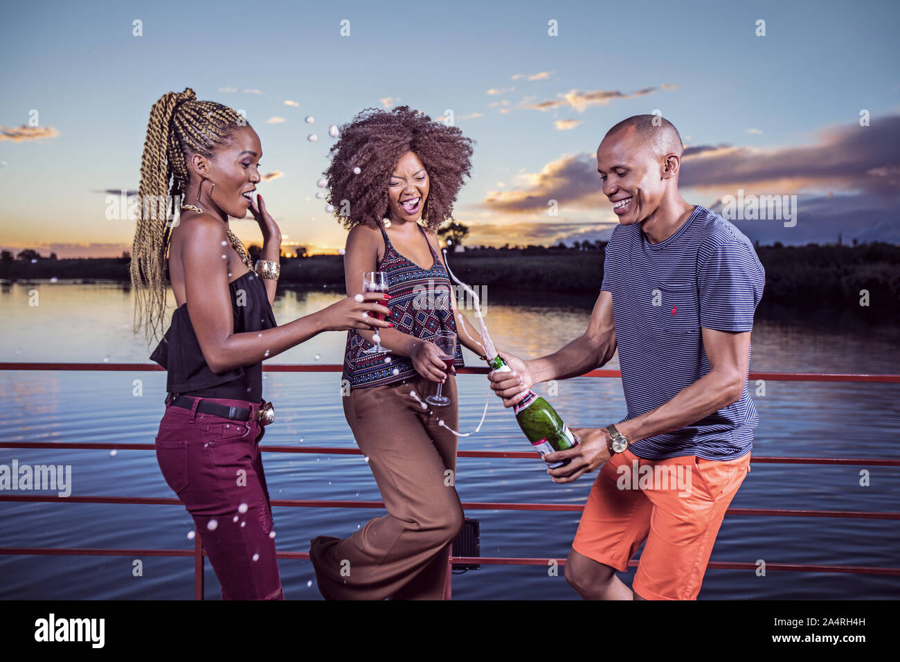 People popping champagne on Sakkie se Arkie sunset cruise Stock Photo ...