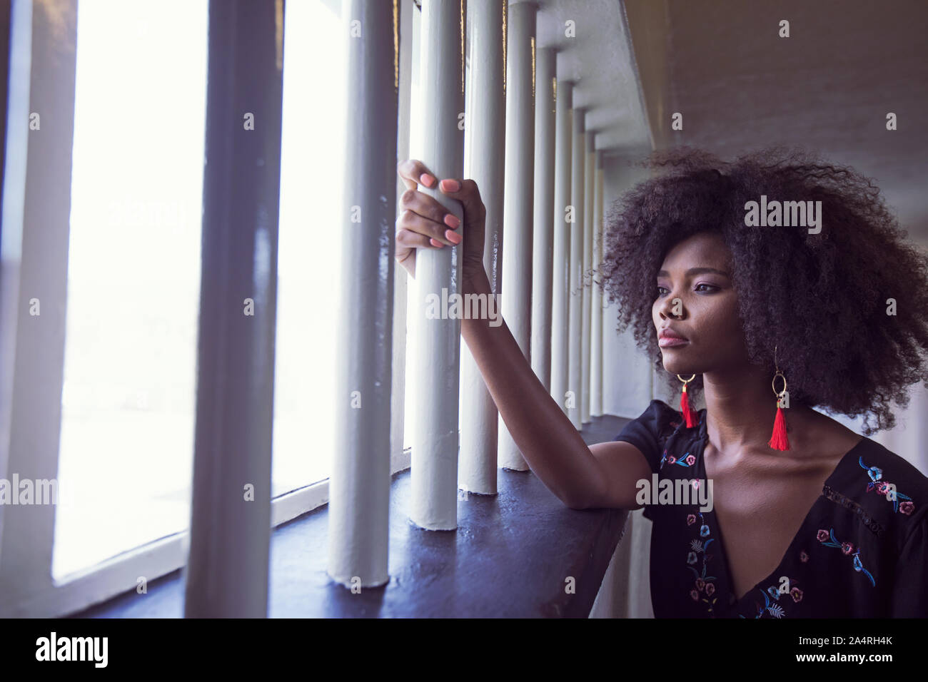 A woman looking through bars on a window on Robben Island Stock Photo ...