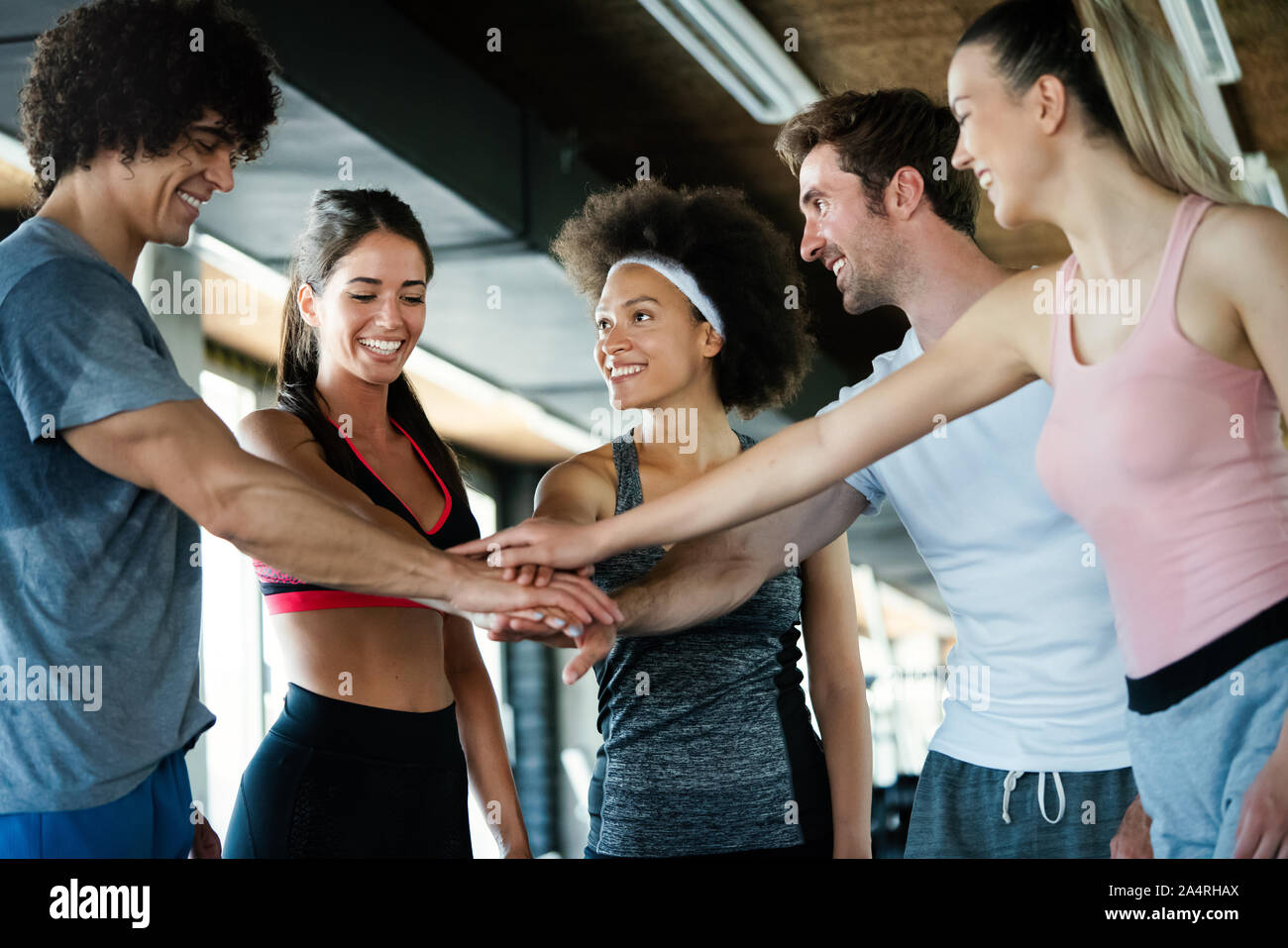 Group of happy multiracial friends exercising together in gym Stock ...