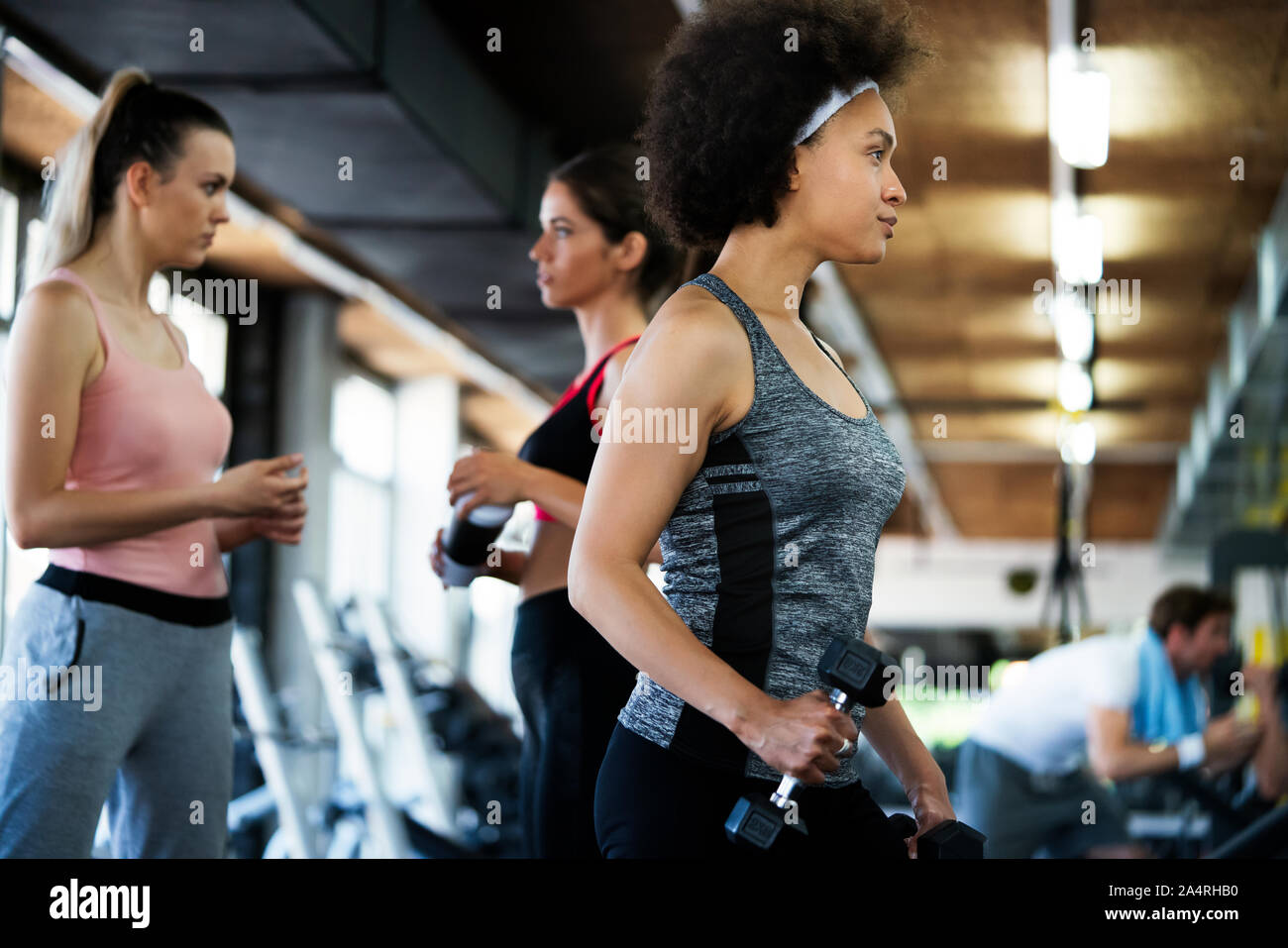 Beautiful fit people exercising together in gym Stock Photo - Alamy