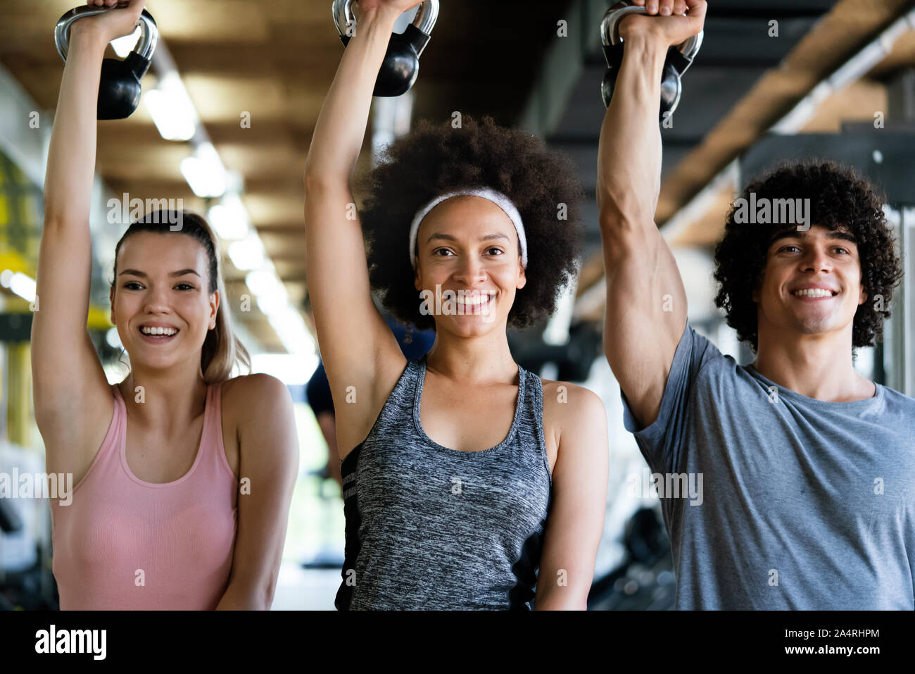 Group of happy multiracial friends exercising together in gym Stock ...