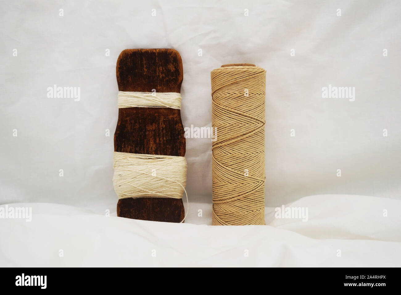 Sewing Thread And Woody Spool With Fabric Background Stock Photo - Alamy