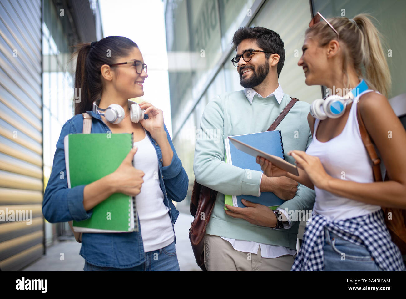 Happy young university students friends studying with books at ...