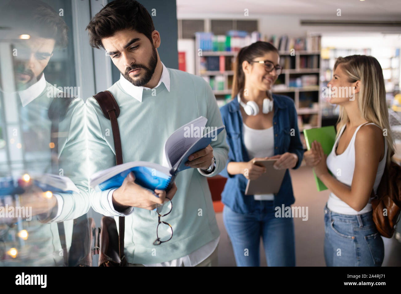Happy young university students studying together. Group of multiracial ...