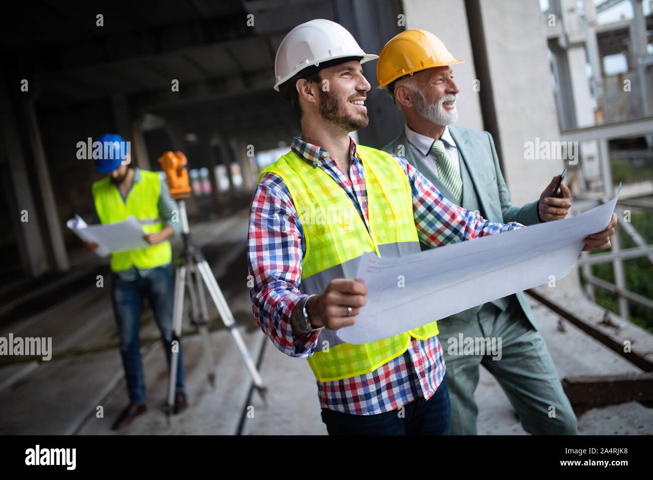 Construction engineer with foreman worker checking construction site ...