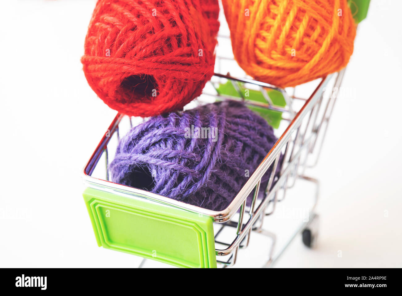 Buy time, Shopping cart with colorful rope over isolated white ...