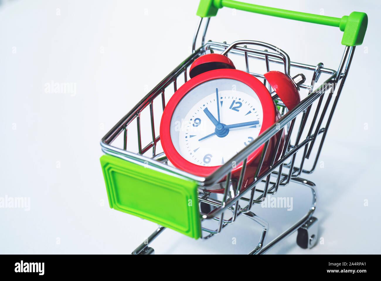 Red clock on the shopping cart, lack of time, waste of time, purchasing ...