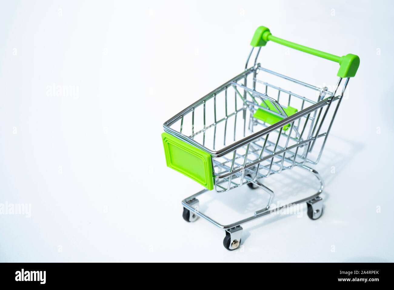 Empty green miniature shopping cart isolated on white background Stock ...