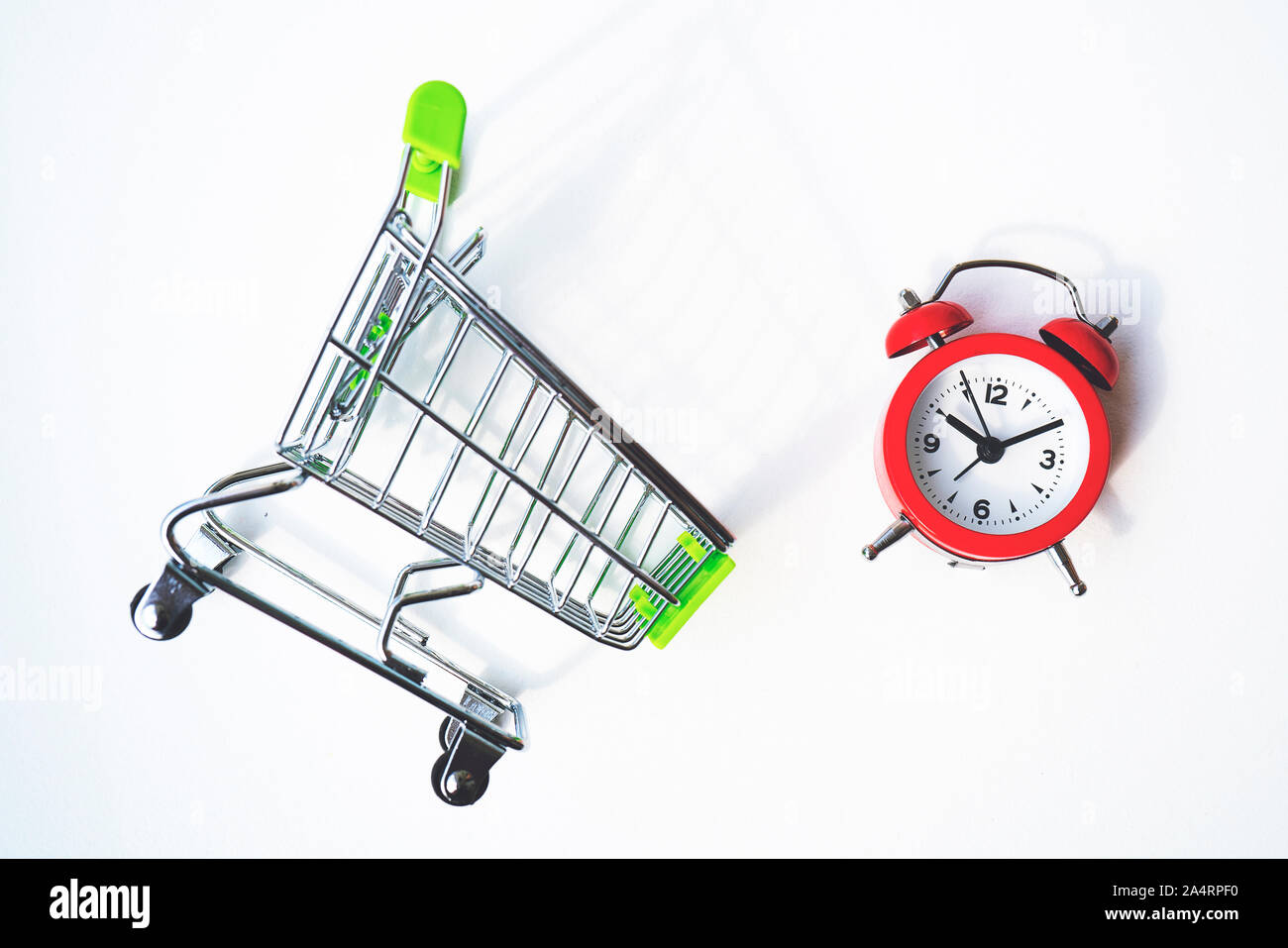 Buying time concept with clock and shopping cart Stock Photo - Alamy
