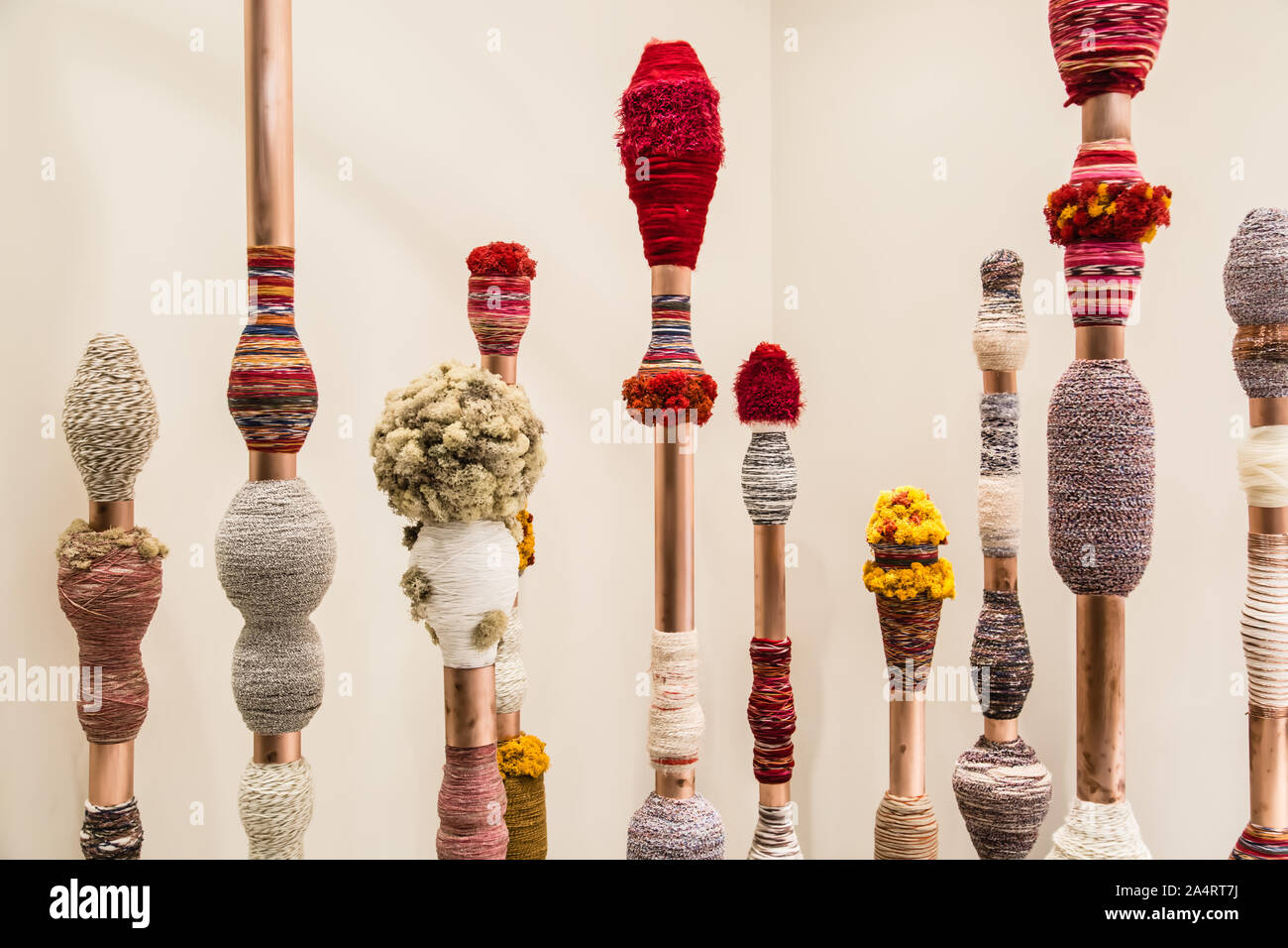 colorful spindles in front of white wall background Stock Photo - Alamy