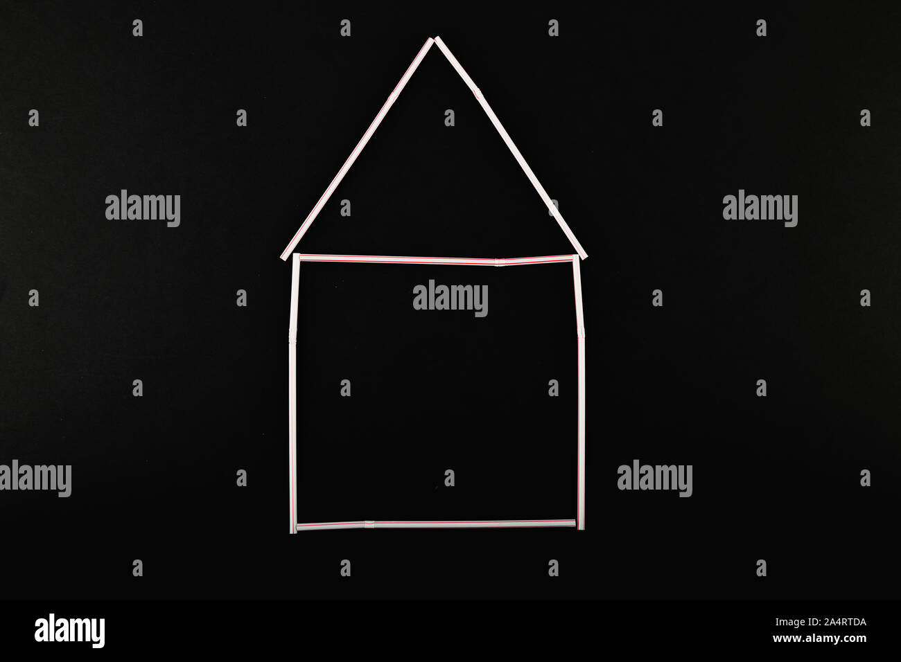 plastic house. Plastic model of the house. On a black background. Real ...