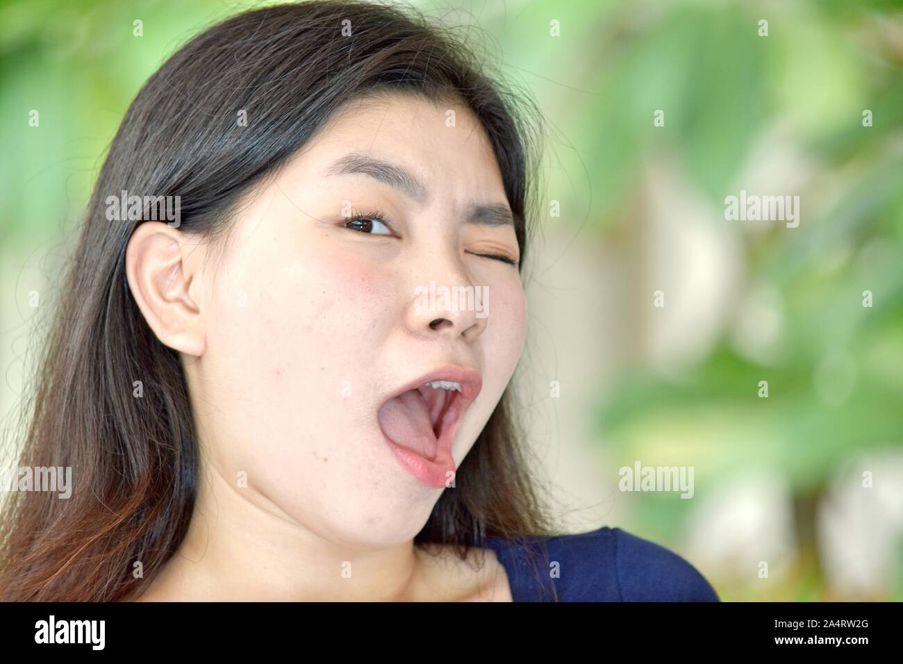 Pretty Chinese Female Winking Stock Photo - Alamy