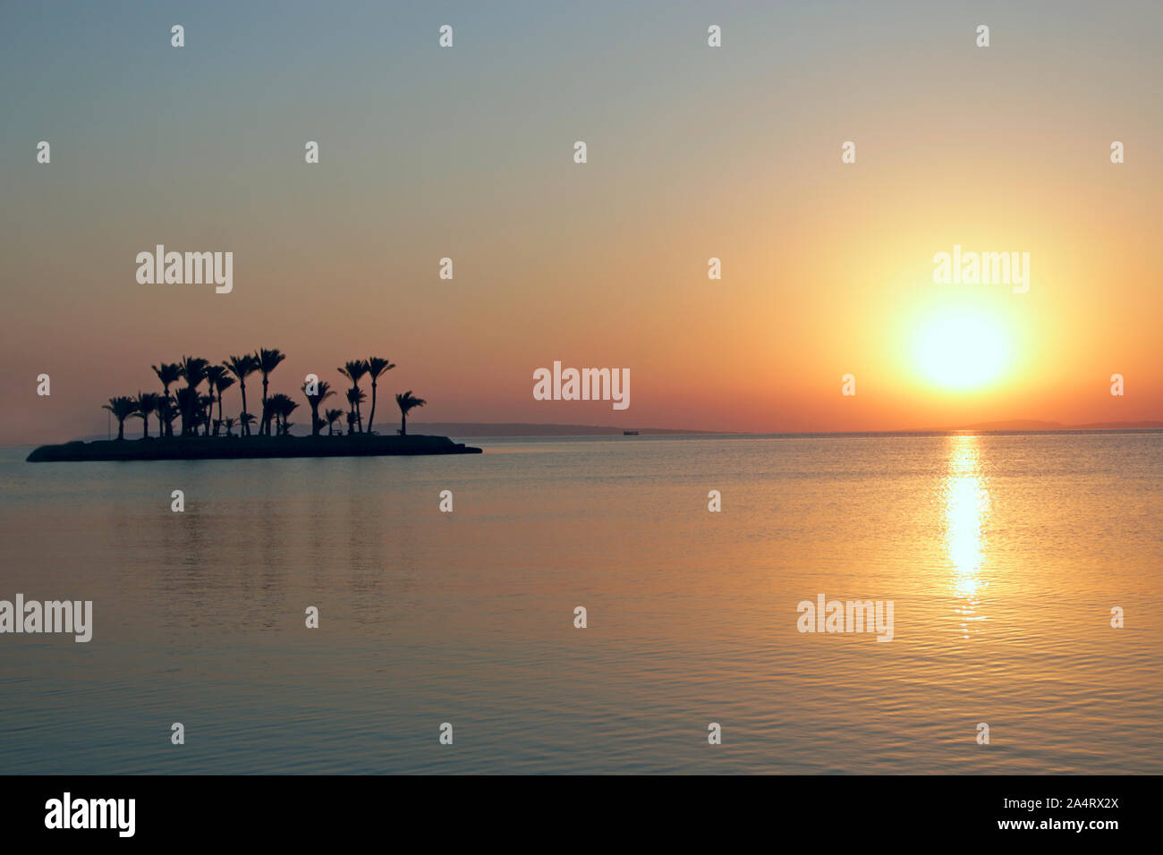 Sunrise over sea with tropical island. Sun riseing over ocean ...