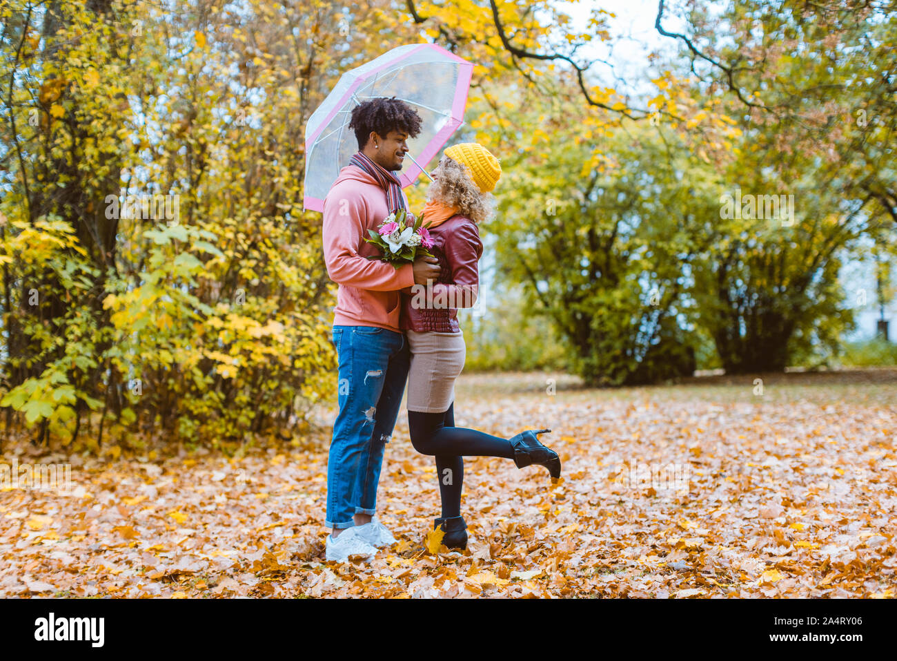 Man and woman of different ethnicity hugging in fall Stock Photo - Alamy