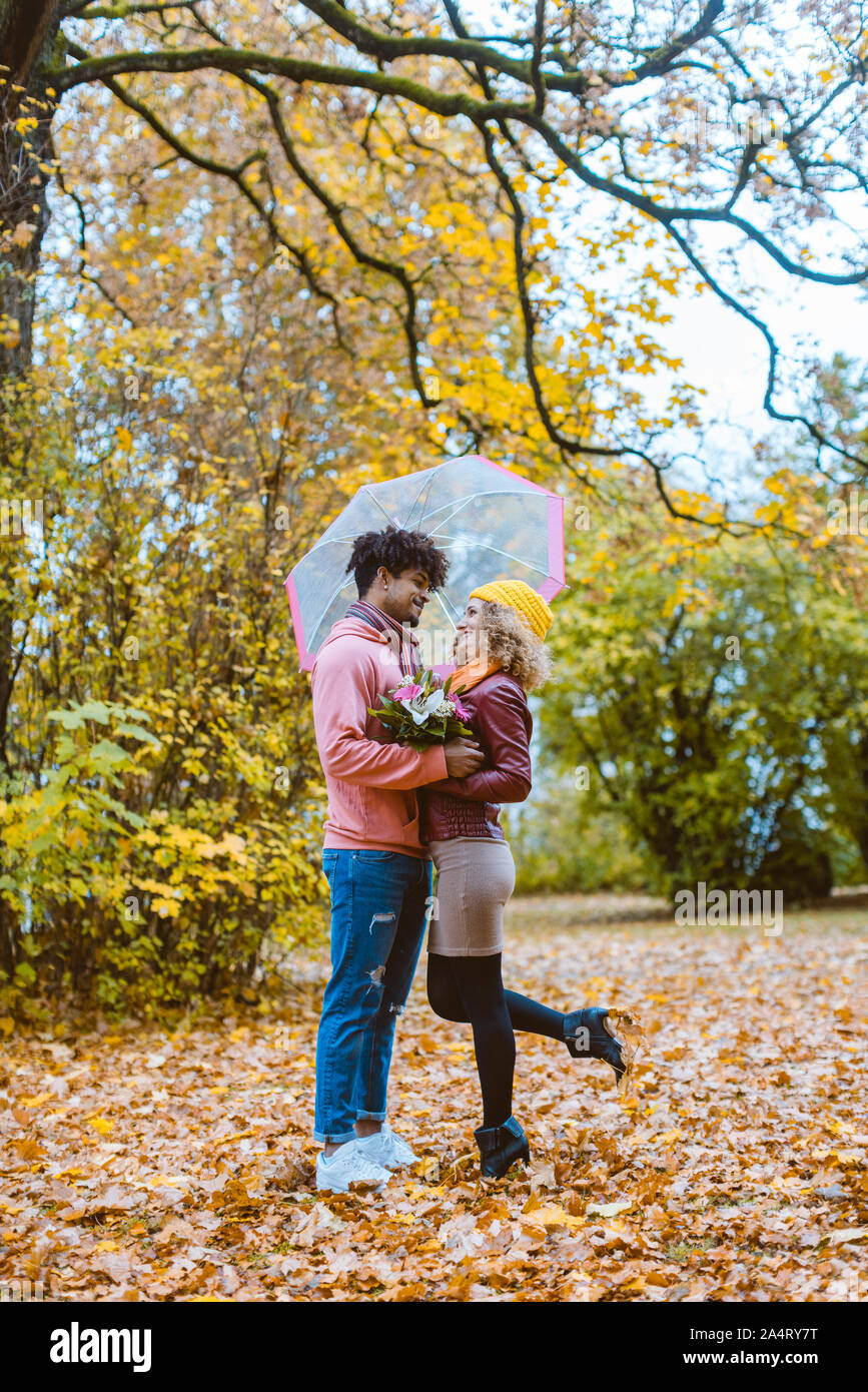 Man and woman of different ethnicity hugging in fall Stock Photo - Alamy