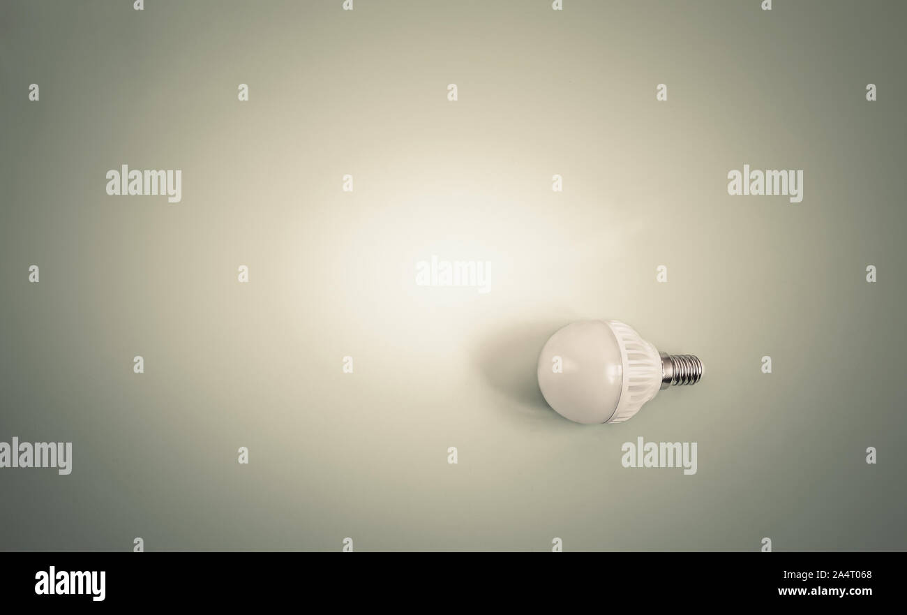 Electric energy-saving lamp on a light background Stock Photo - Alamy