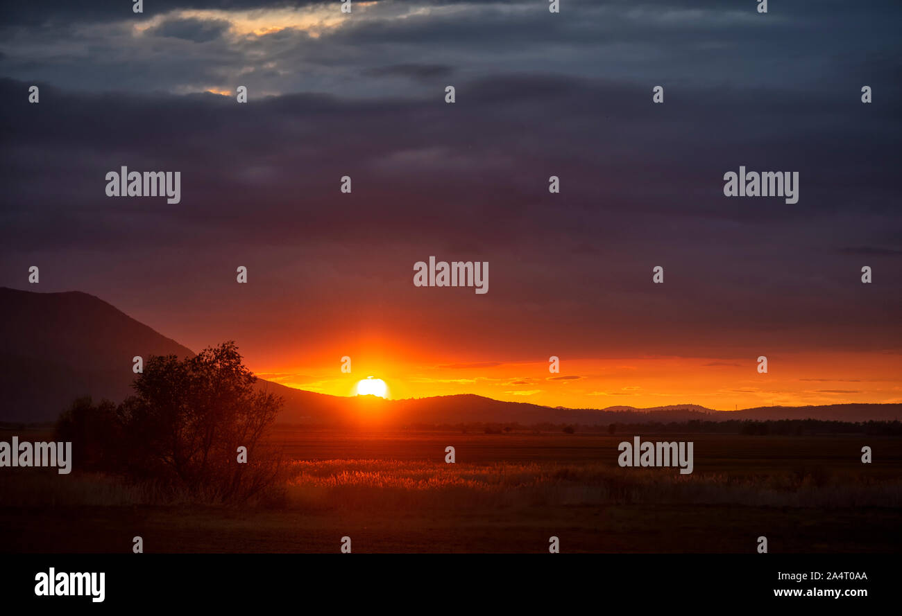 beautiful sunset over the hils in summer time Stock Photo - Alamy