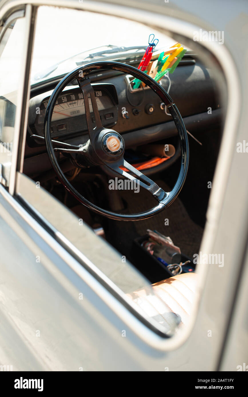 Steering wheel on vintage car. View from the door window. Opened window ...