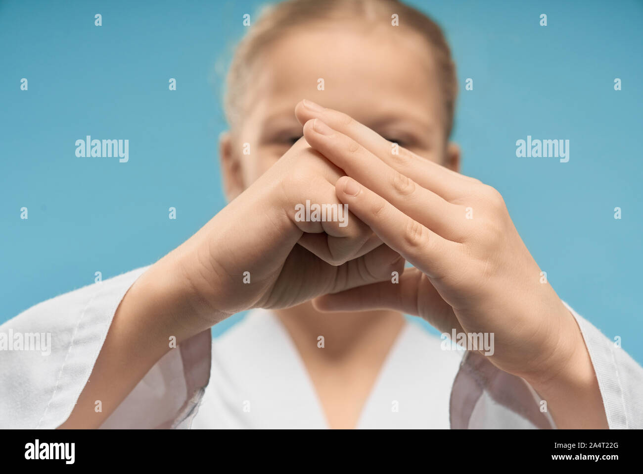 Hand position of karate close up. Girl in white kimono showing fist ...