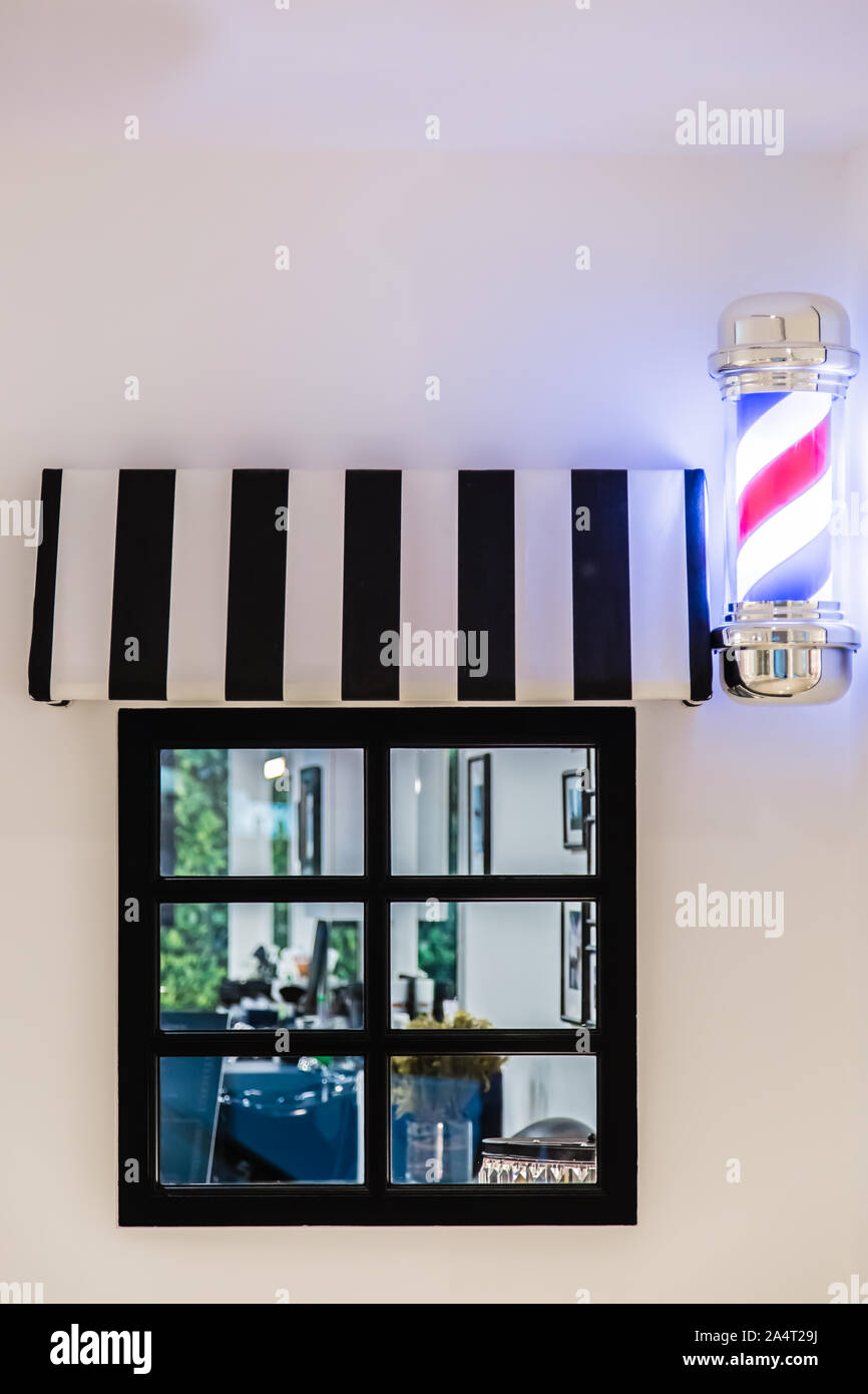 small barbershop window on white wall facade Stock Photo - Alamy