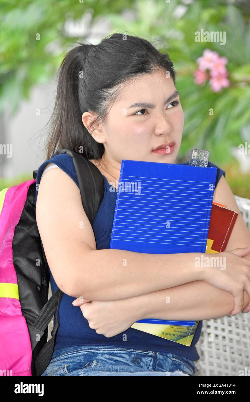 Young Chinese Girl Student And Confusion With Books Stock Photo - Alamy
