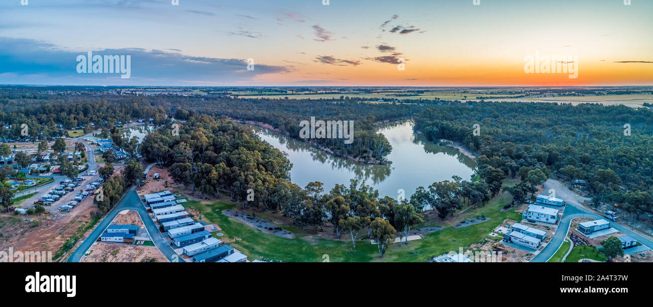 Aerial panorama of holiday park cabins on the shores of Murray RIver in ...