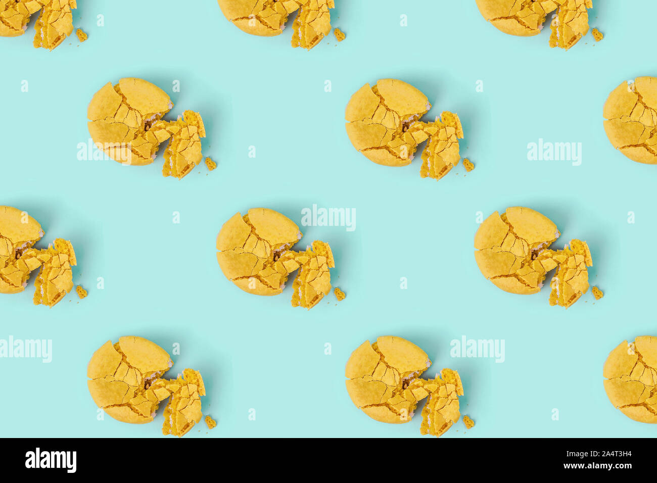 Pattern made of crushed yellow macaroons on pastel blue background ...