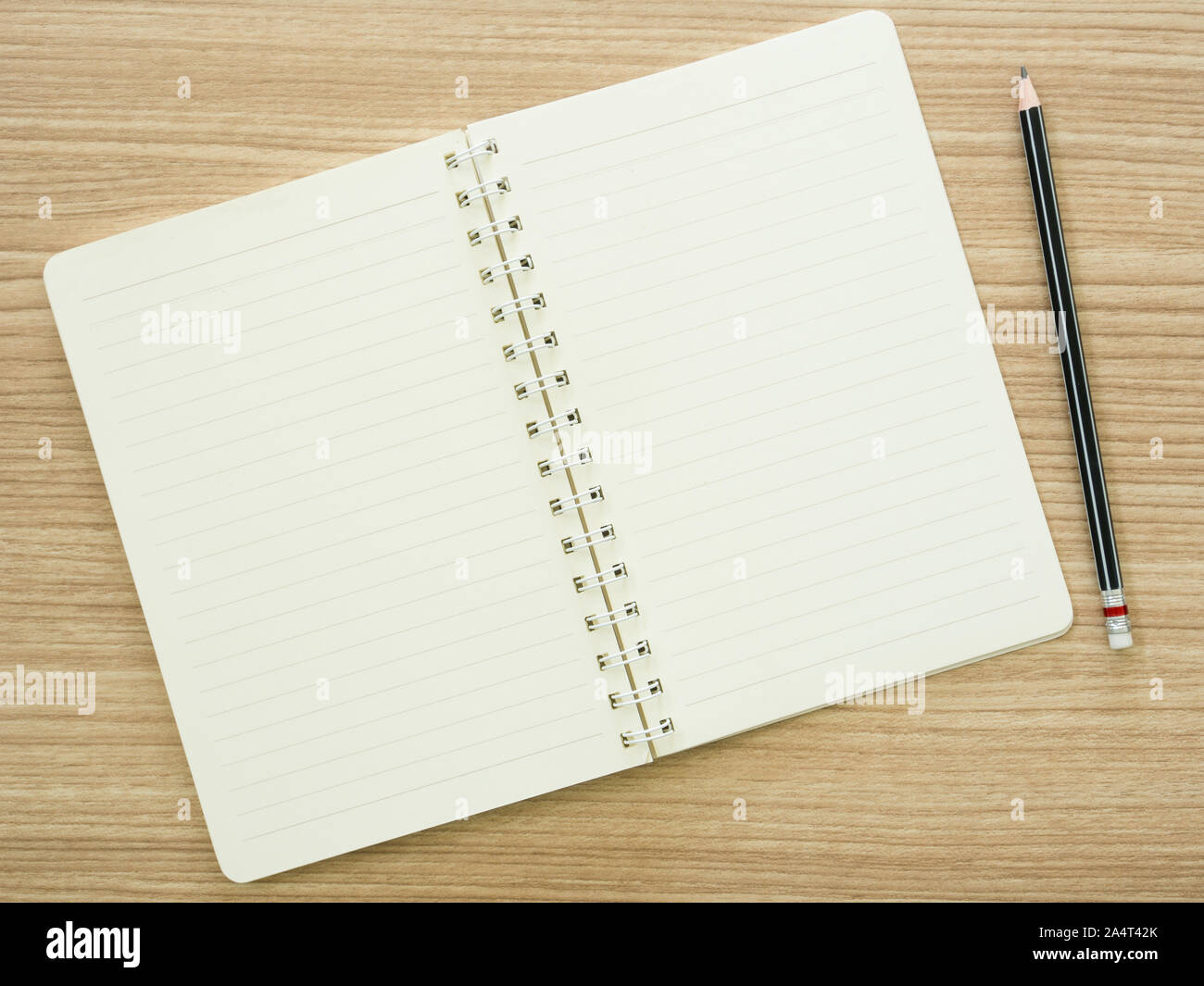 opened notebook and pencil on desk. view top Stock Photo - Alamy